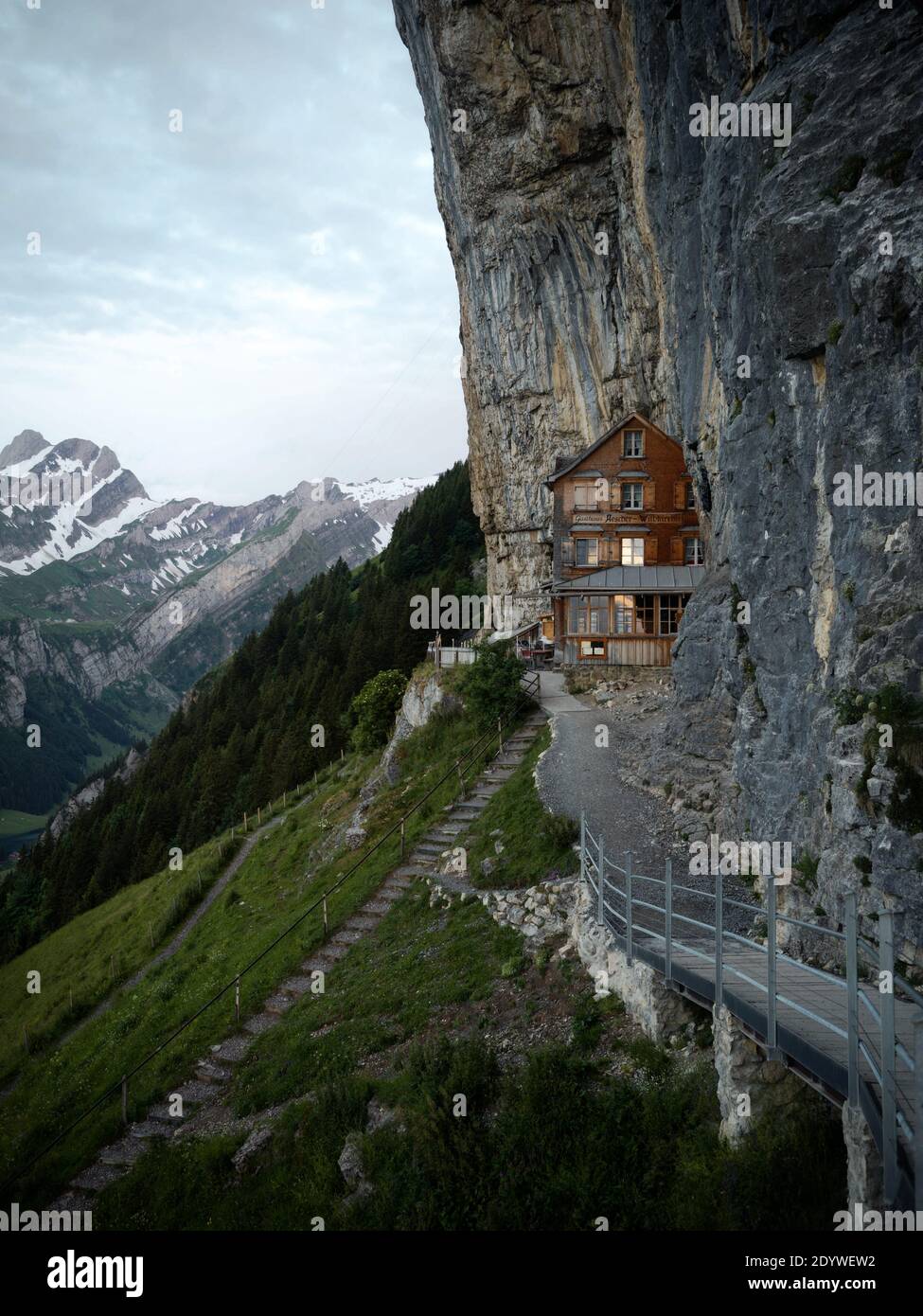 Famous guesthouse Aescher-Wildkirchli built into limestone cliff wall ...