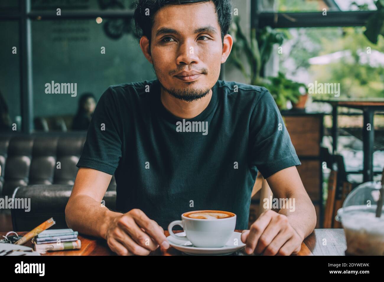 Man sitting in coffee shop hi-res stock photography and images - Alamy