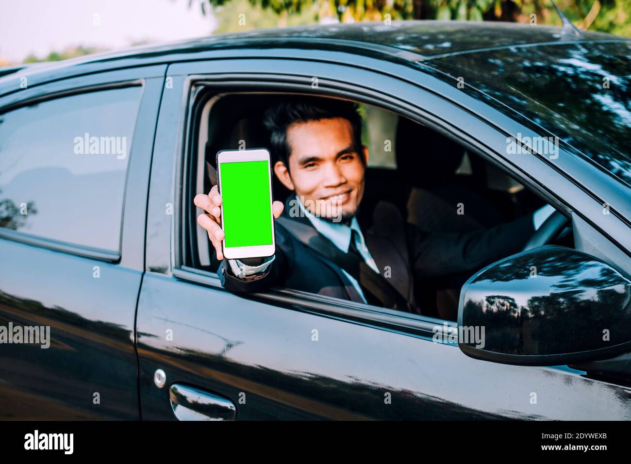 Man holding mobile smartphone showing on phone screen and sitting car ...