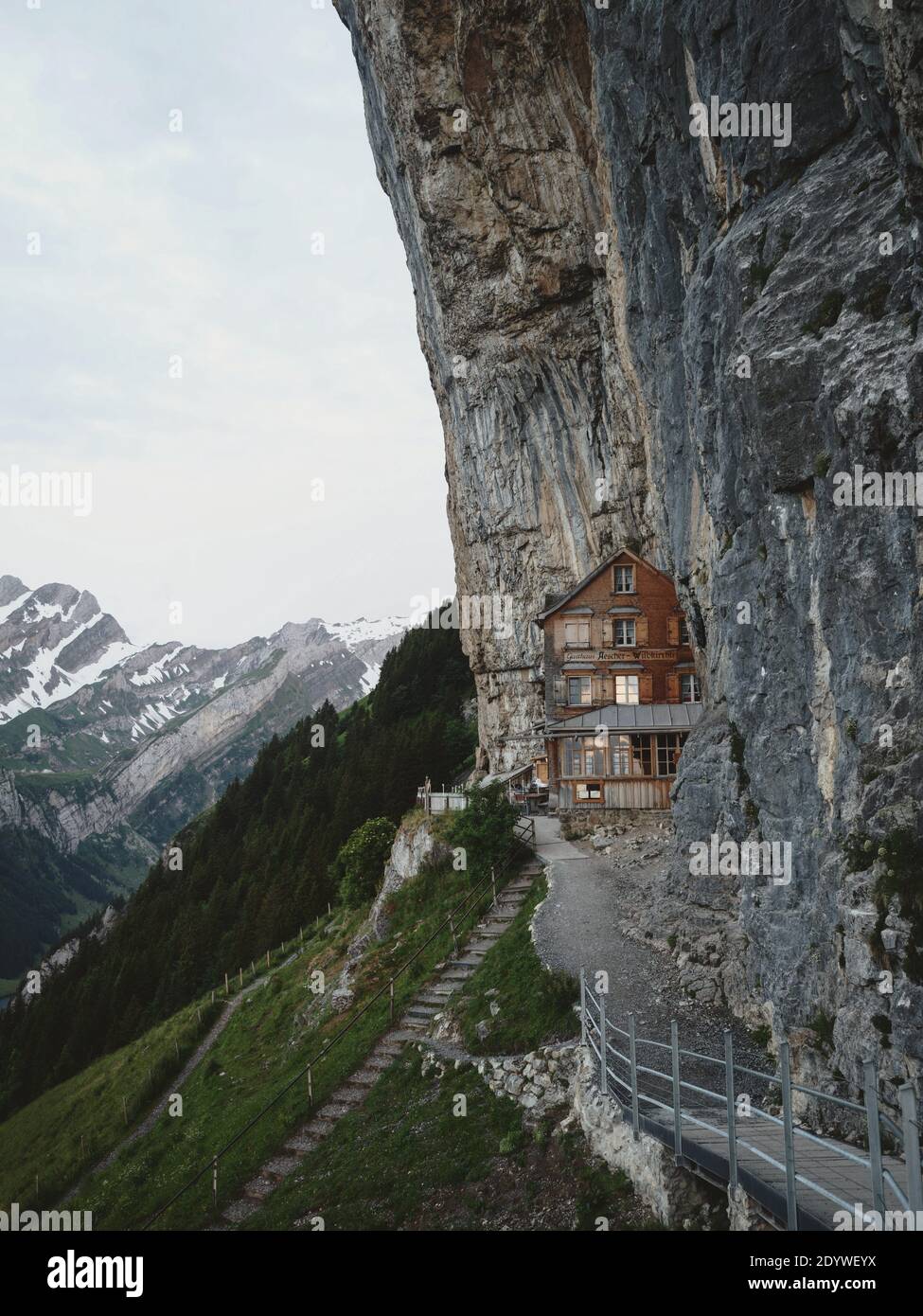 Famous guesthouse Aescher-Wildkirchli built into limestone cliff wall ...