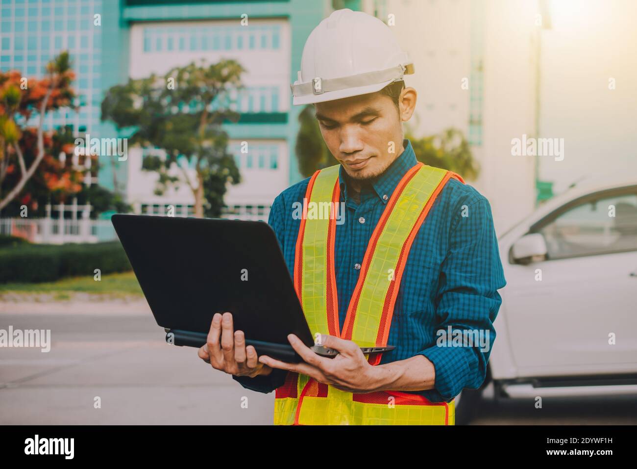 Engineer holding computer working on side technology Stock Photo - Alamy