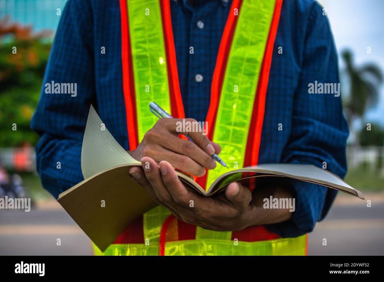 Engineer write take note on book for planing work Stock Photo - Alamy