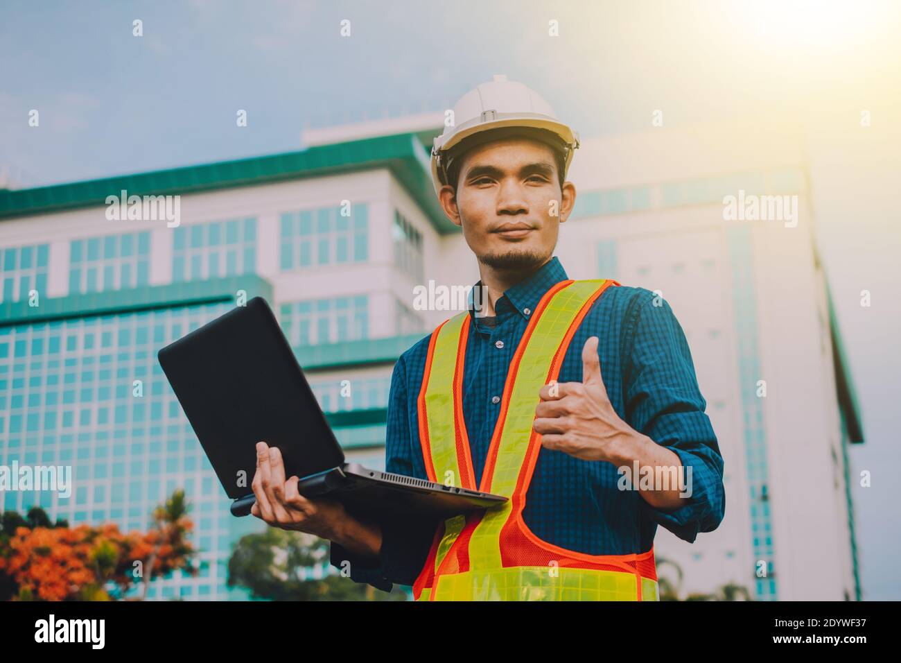 Engineer holding computer working on side technology Stock Photo - Alamy