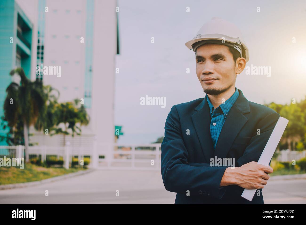 Engineer holding paper factory plant background Stock Photo - Alamy
