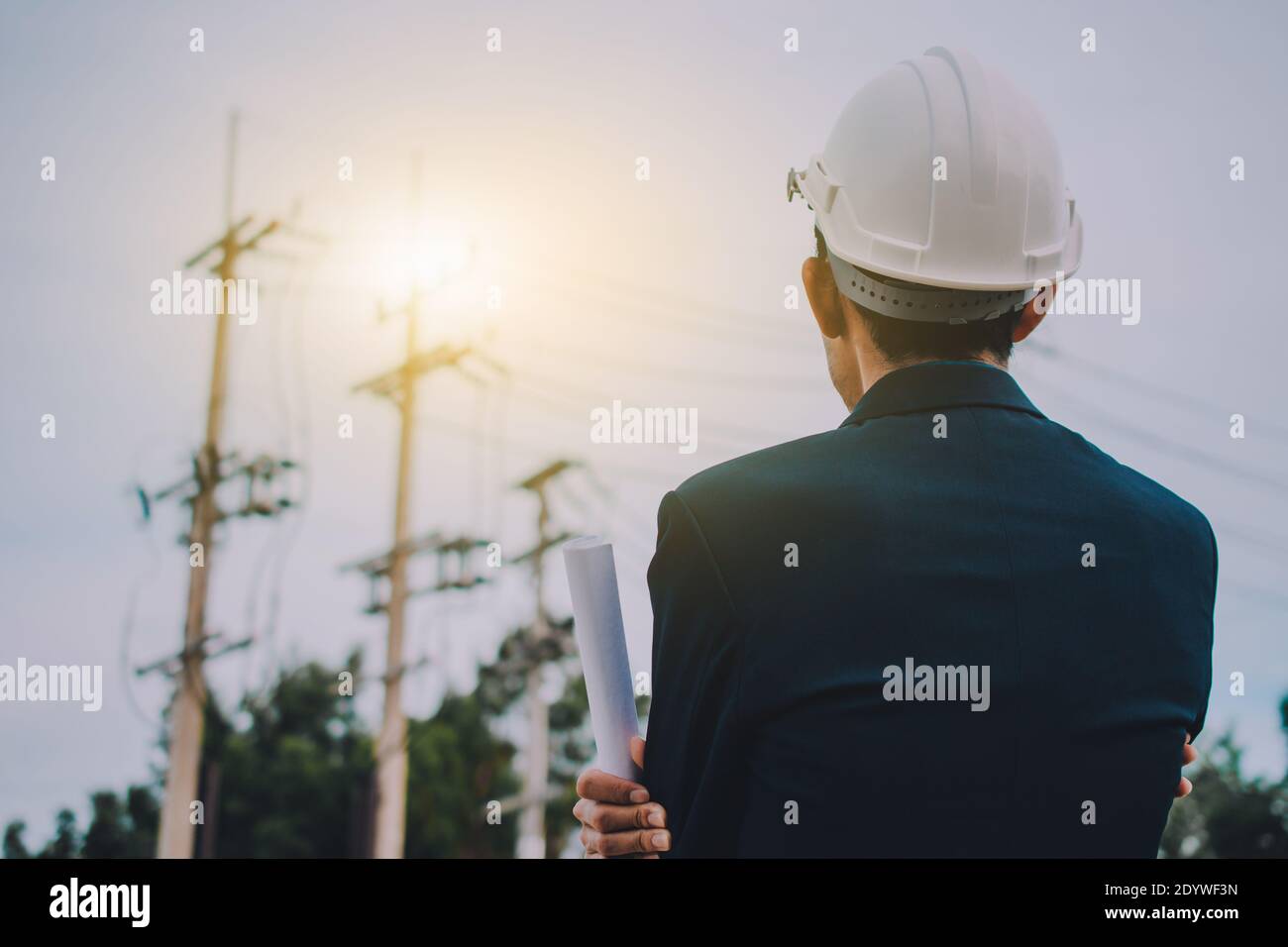 Engineer holding paper factory plant background Stock Photo - Alamy