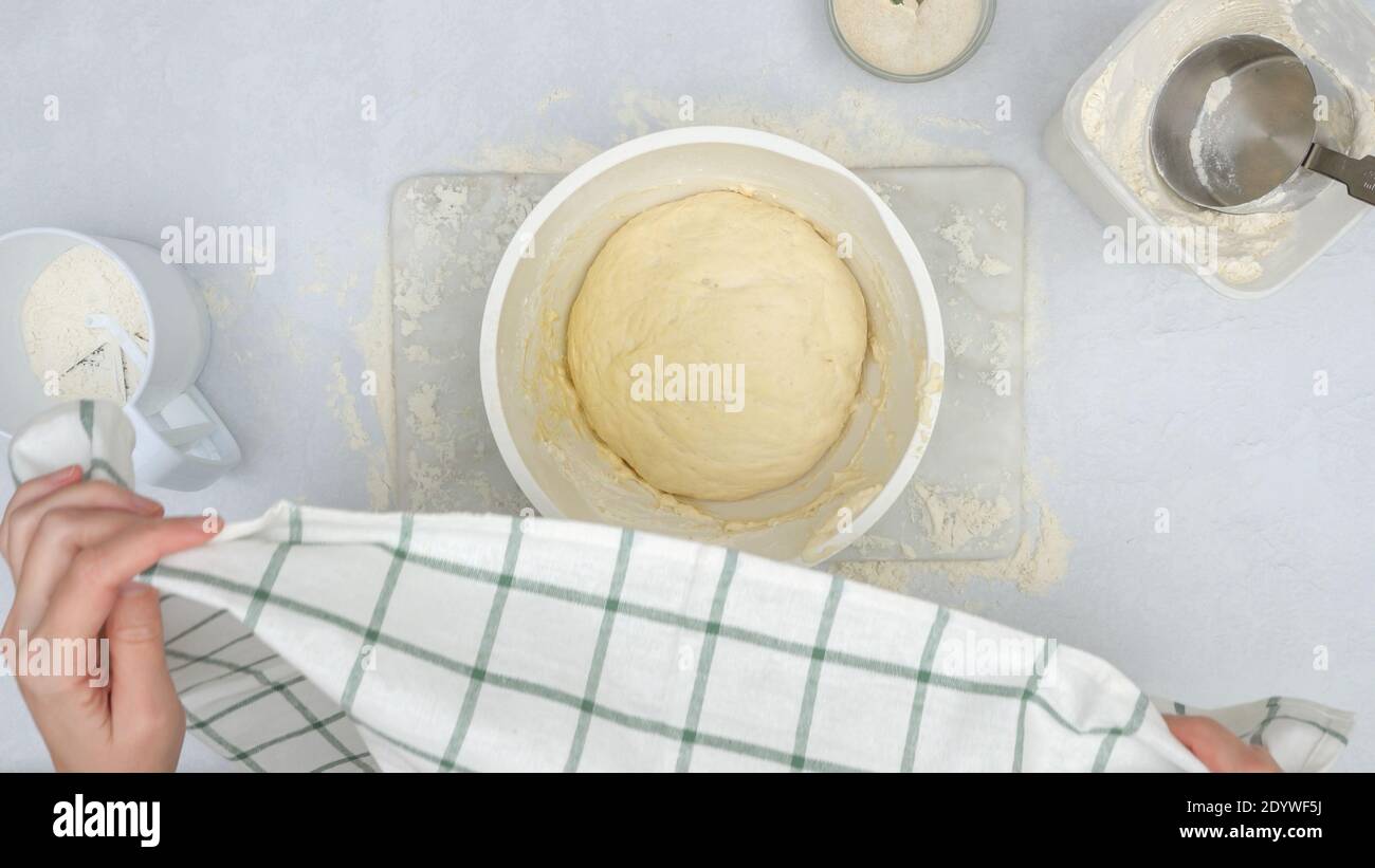 Raised bread dough in a bowl, view from above. Step by step cheese ...