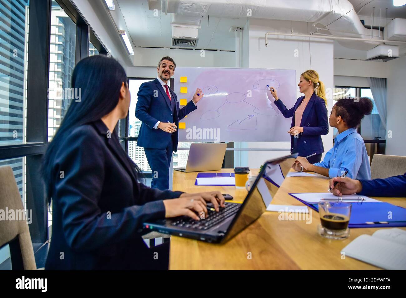 Business team working group meeting in office Stock Photo - Alamy