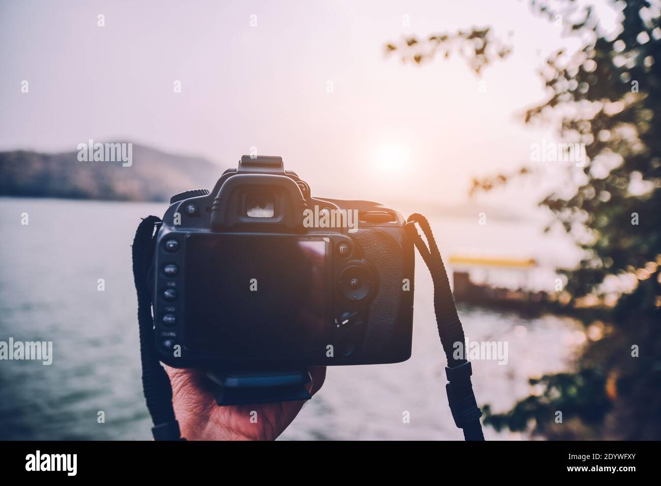 Hand holding Camera DSLR taking photo Stock Photo - Alamy