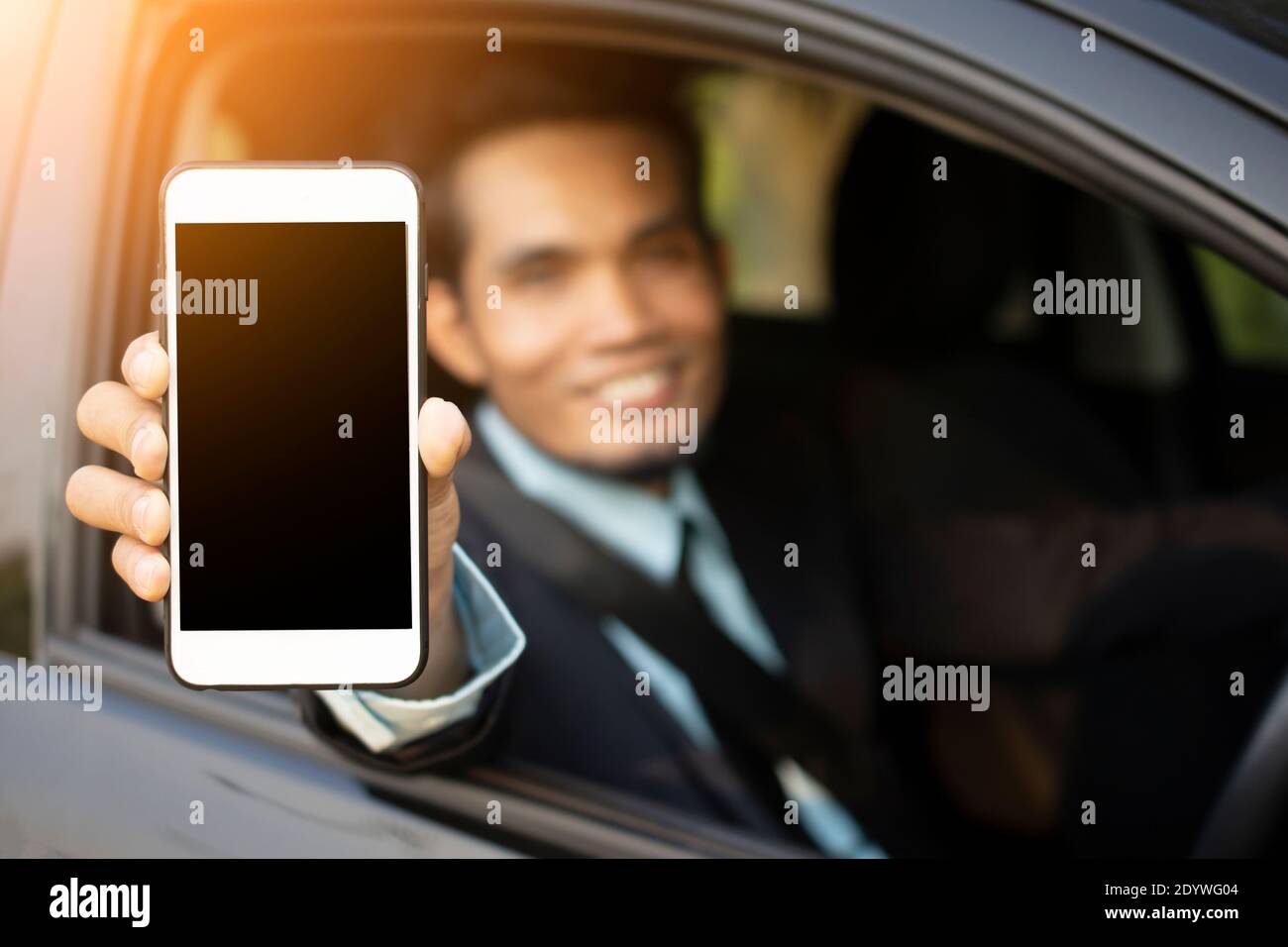 Man holding mobile smart phone in car Stock Photo - Alamy