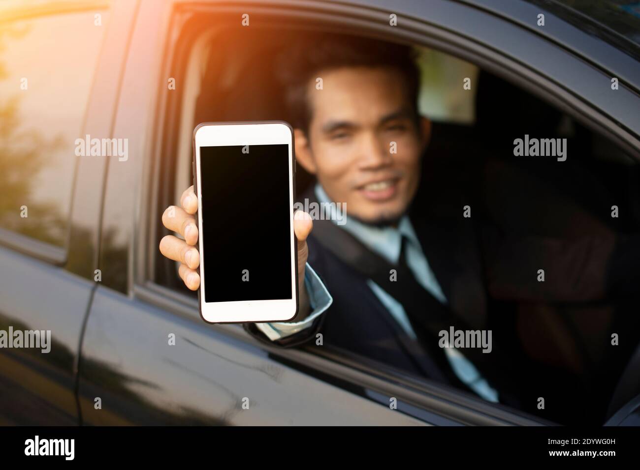 Man holding mobile smart phone in car Stock Photo - Alamy
