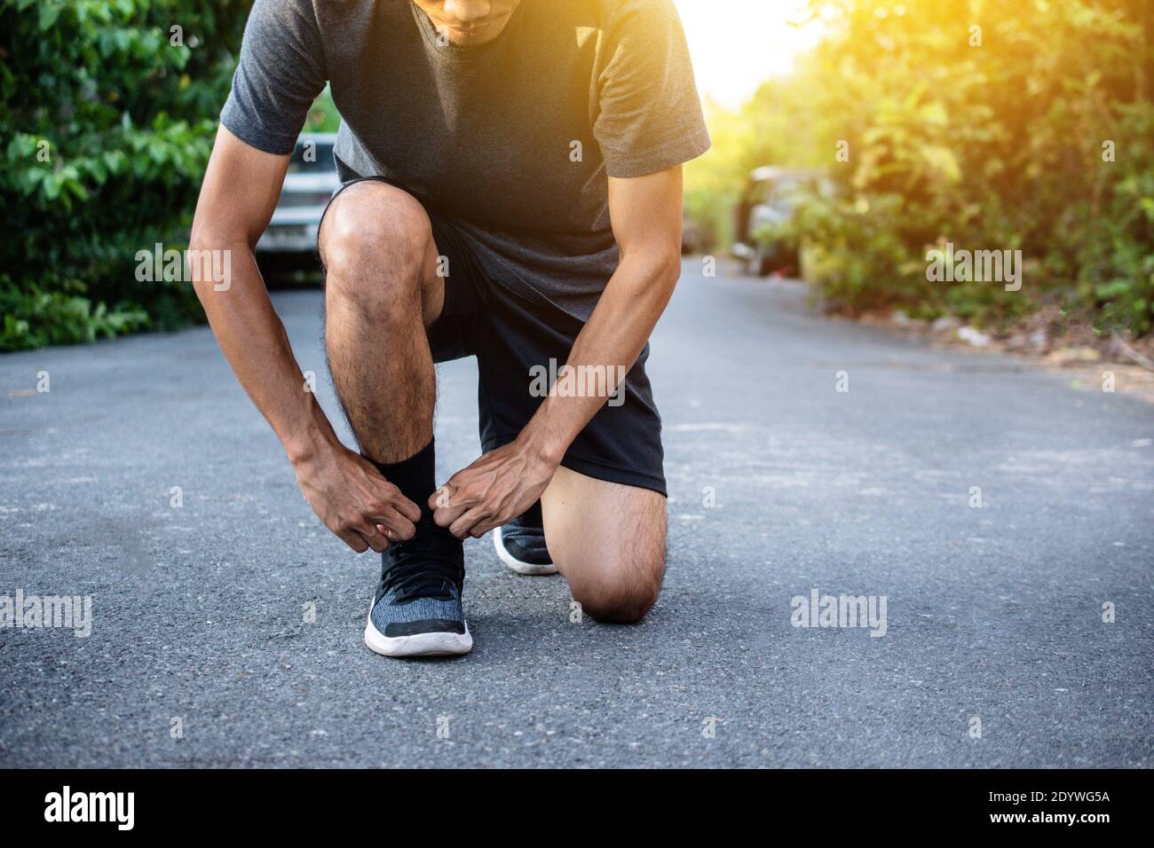 Men are binding shoes before jogging Stock Photo - Alamy