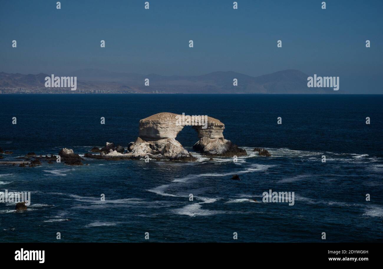 Natural arch rock formation La Portada in pacific ocean near coast of ...