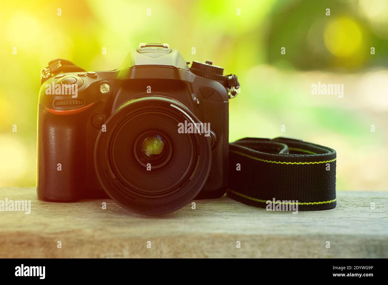 Camera DSLR on Wooden table background And Green nature background ...
