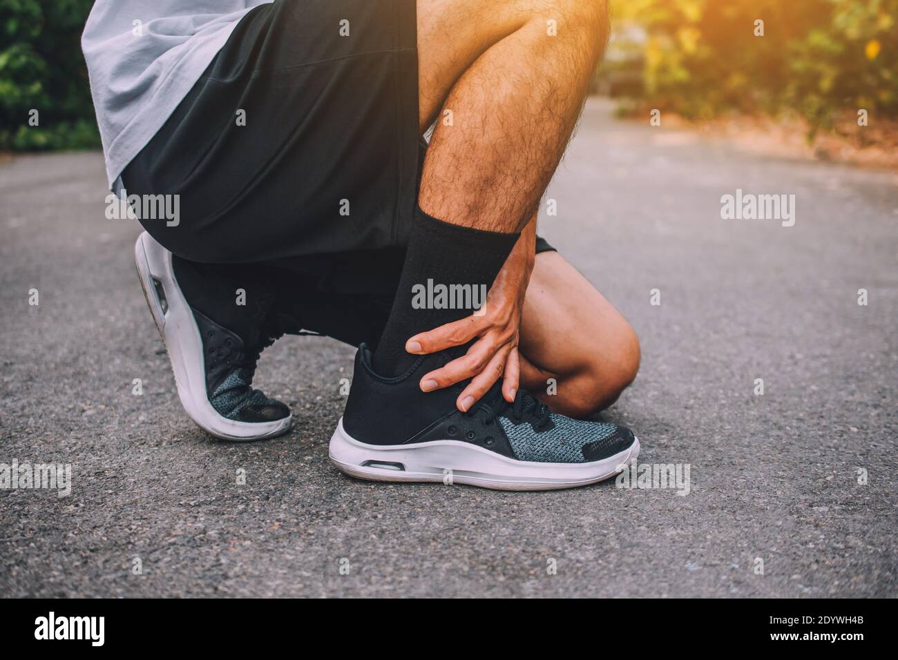 Runners injured on the ankle,Man running on the street be running for ...