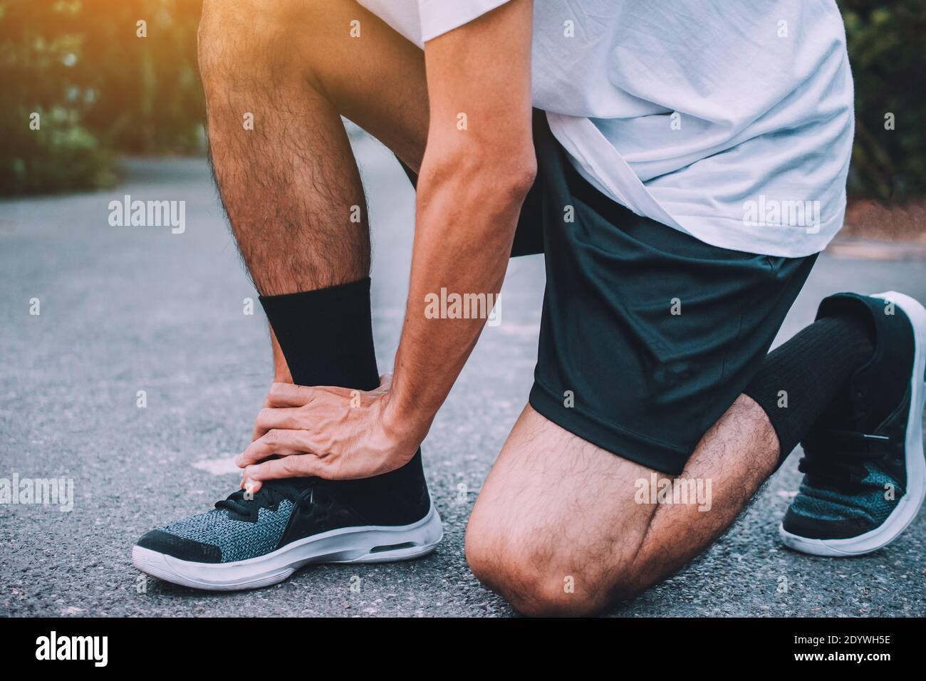 Runners injured on the ankle,Man running on the street be running for ...