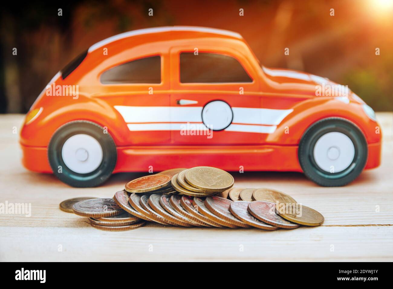 Car model on wooden table with thai baht coin saving money or insurance ...