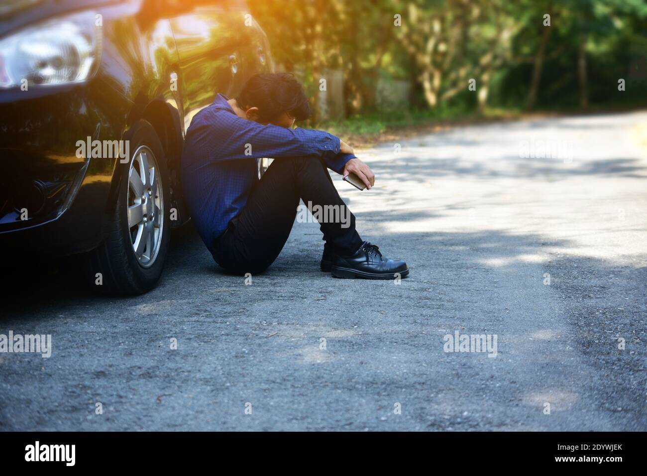 Men were disappointed and saddened, sitting beside the car Stock Photo ...
