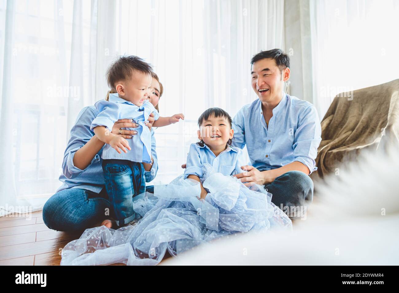 Happy Asian family smile and laugh together in bedroom at home. Two ...