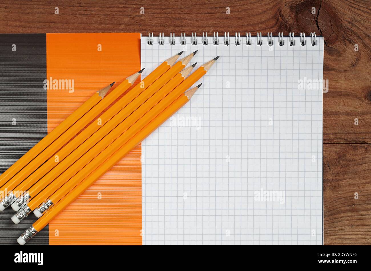 Notepad and pencils on wood table, top view. Space for your text Stock ...