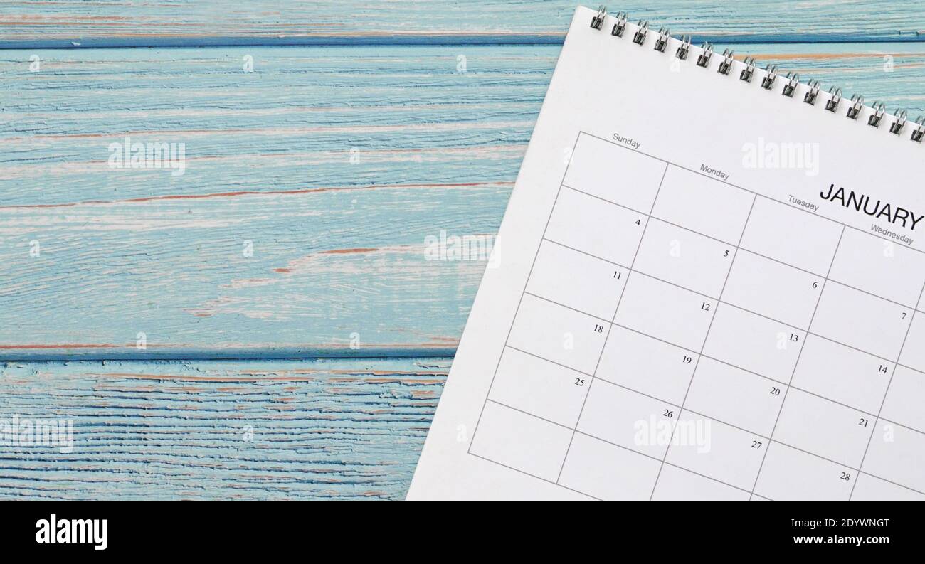Calendar page on pastel blue color wood table background. Copy space ...