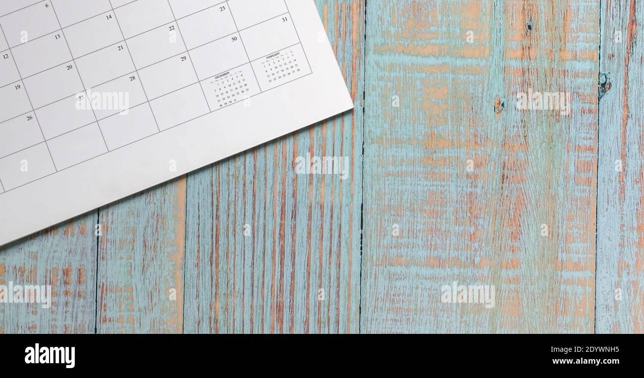 Calendar page on pastel blue color wood table background. Copy space ...