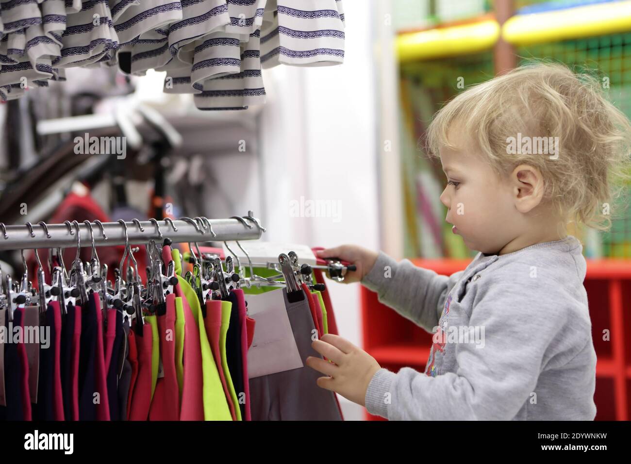 Serious boy choosing clothes in a market Stock Photo - Alamy
