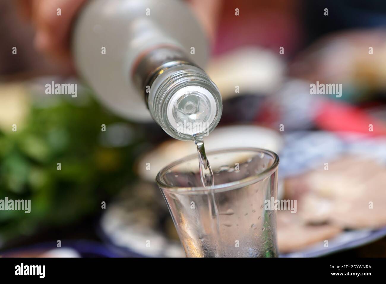 Person pouring vodka into glass at restaurant Stock Photo - Alamy