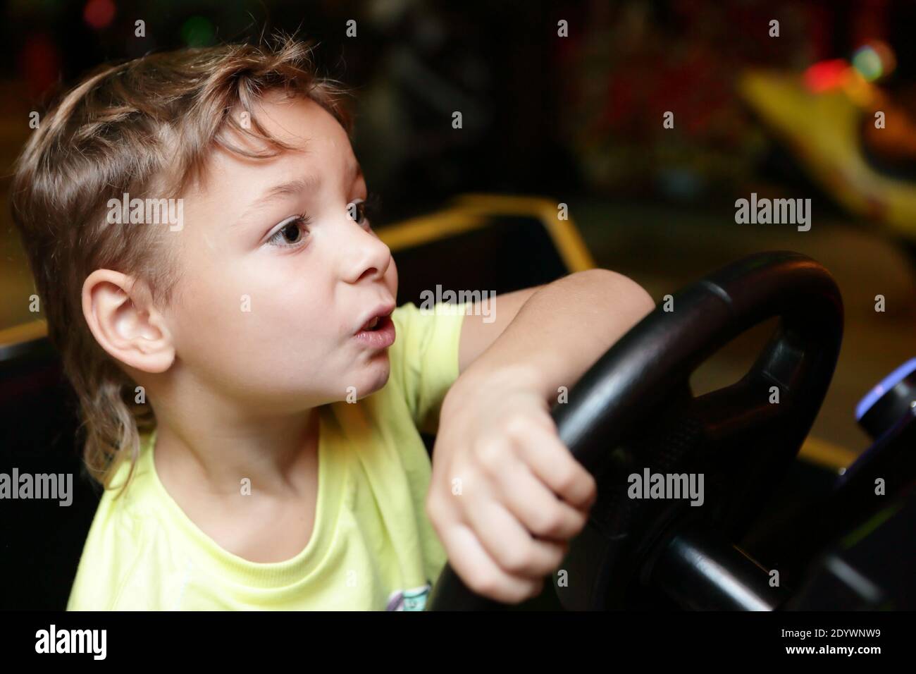 Child driving a car simulator at an amusement park Stock Photo - Alamy