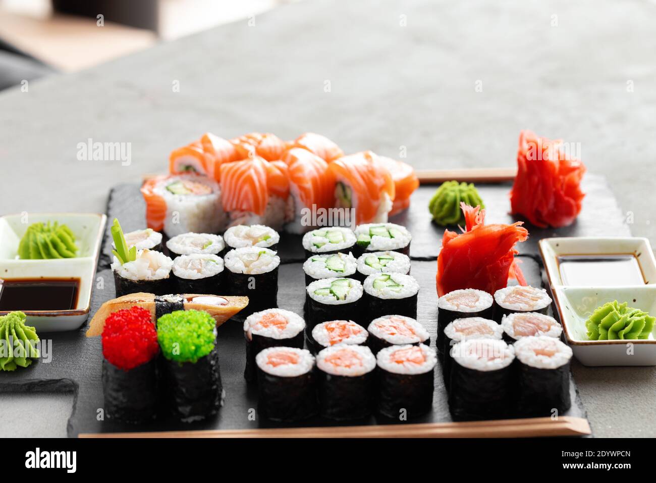 Maki sushi set served on black stone tray Stock Photo - Alamy
