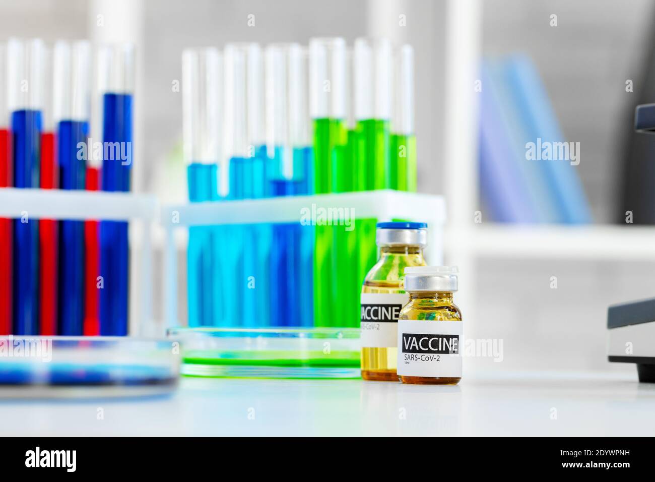 Vaccine in vial for injection on table against background of laboratory ...