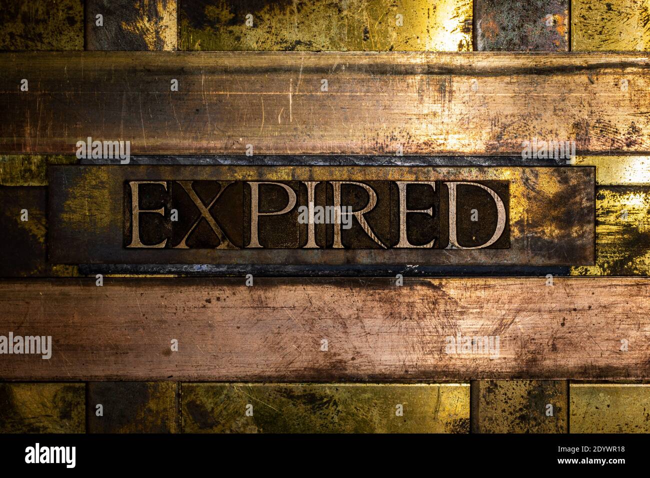Expired text on vintage grunge textured copper and gold background ...