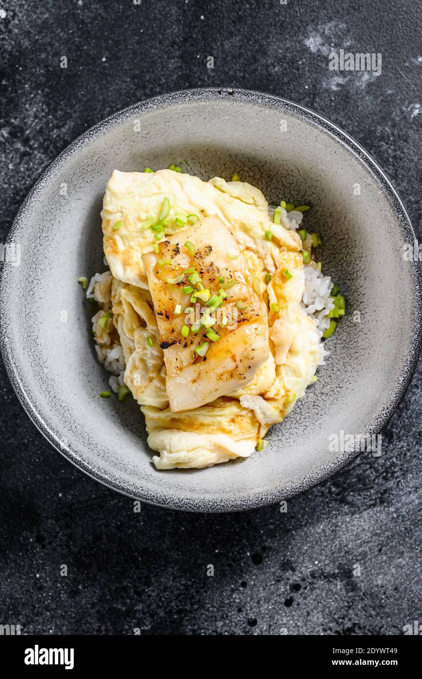 Baked cod fillet with Japanese omelette and fried rice. Black ...