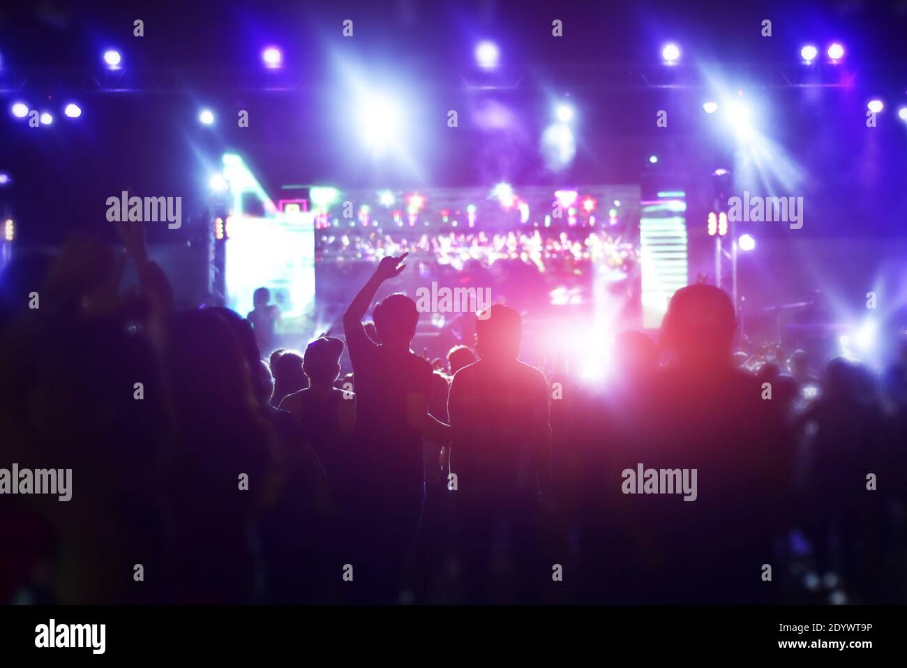 people dancing and holding hand up in party concert Stock Photo - Alamy