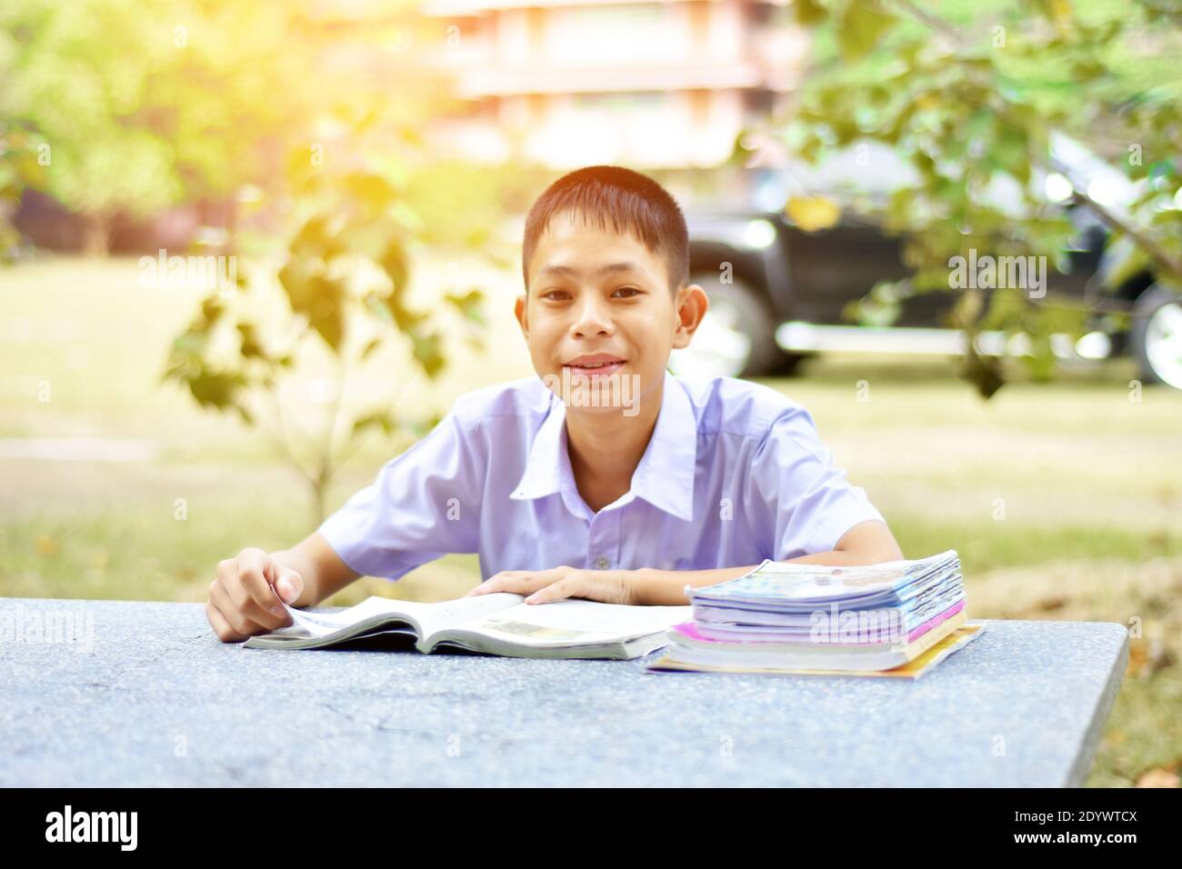 Boy reading a book Stock Photo - Alamy