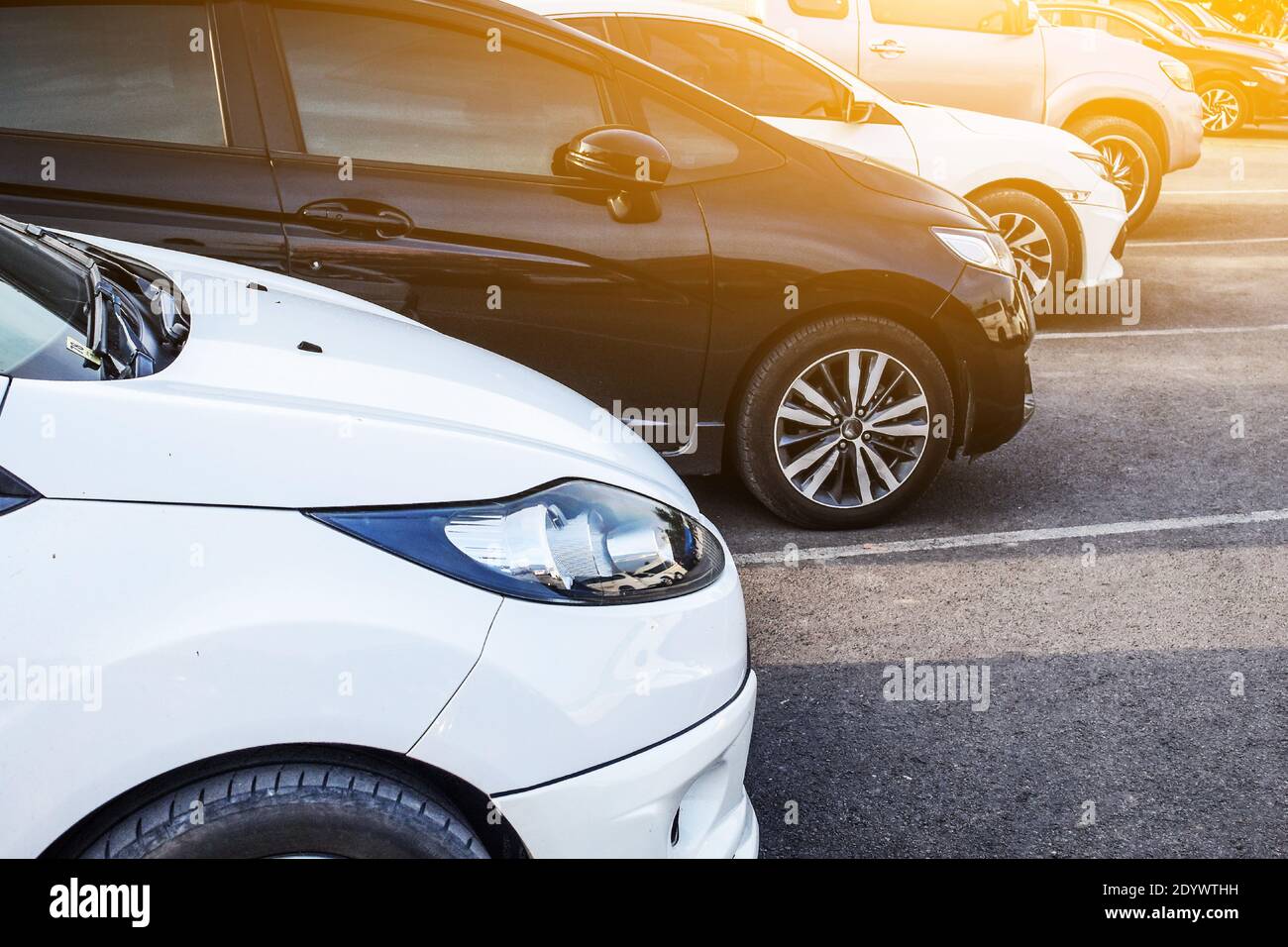 Car parked row on road,Car a lot parking in line and sunset Stock Photo ...