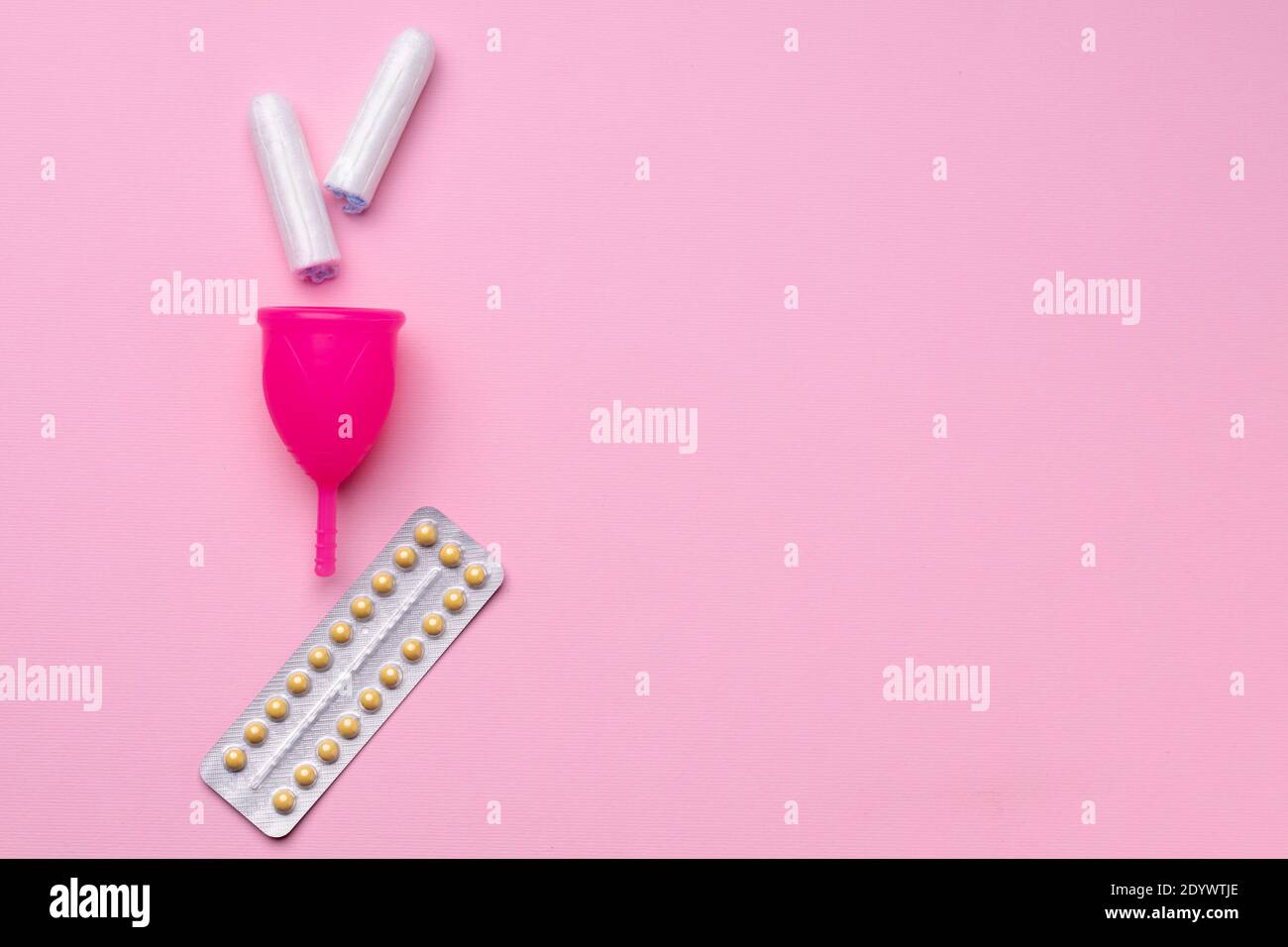 Menstrual cup and oral contraceptive pills top view Stock Photo - Alamy