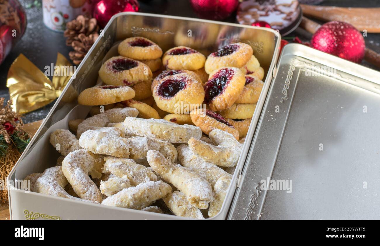 A box with christmas cookies on a kitchen table with xmas decoration ...