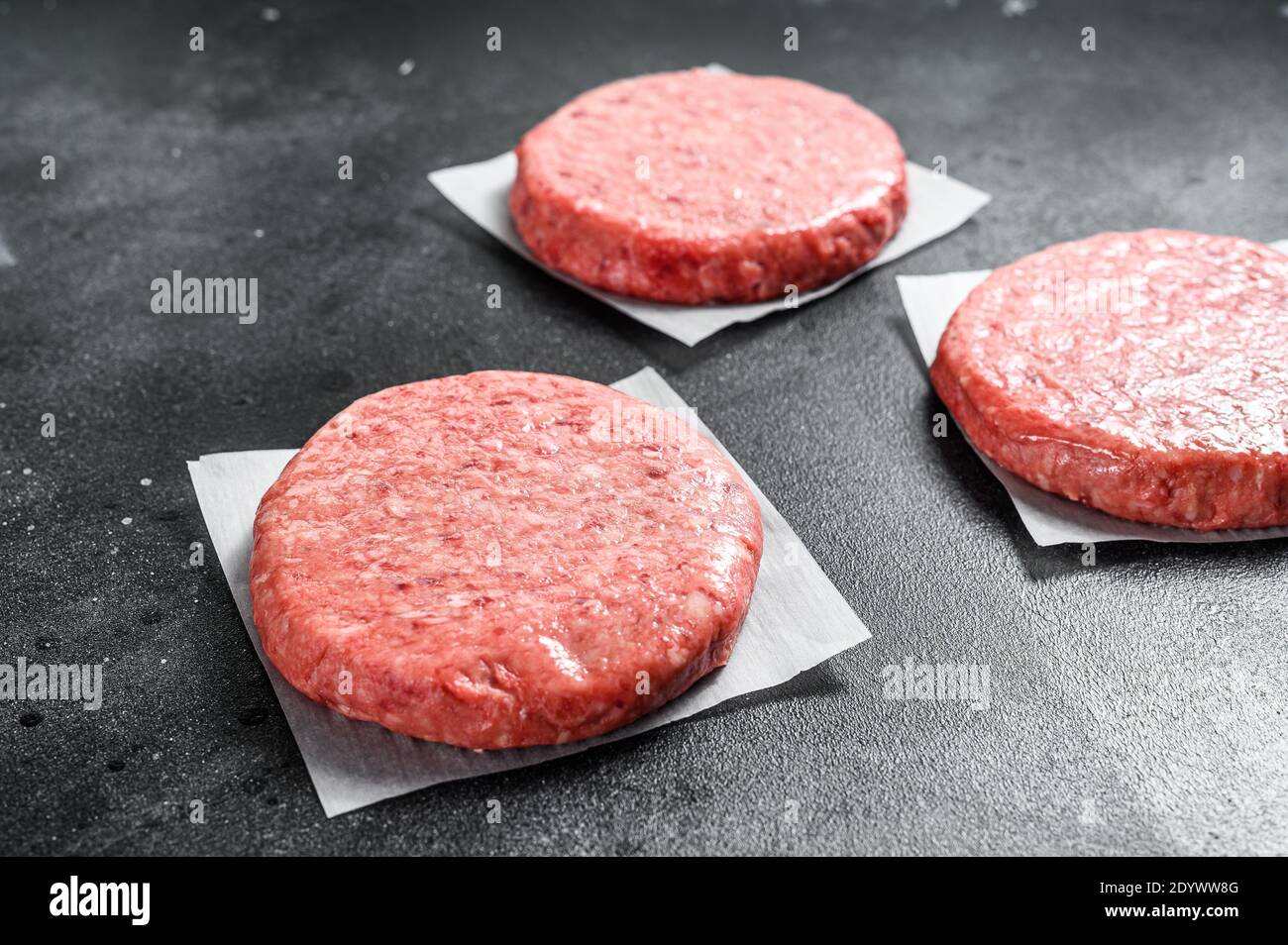 Raw Burger patties, ground beef meat. Black background. Top view Stock ...