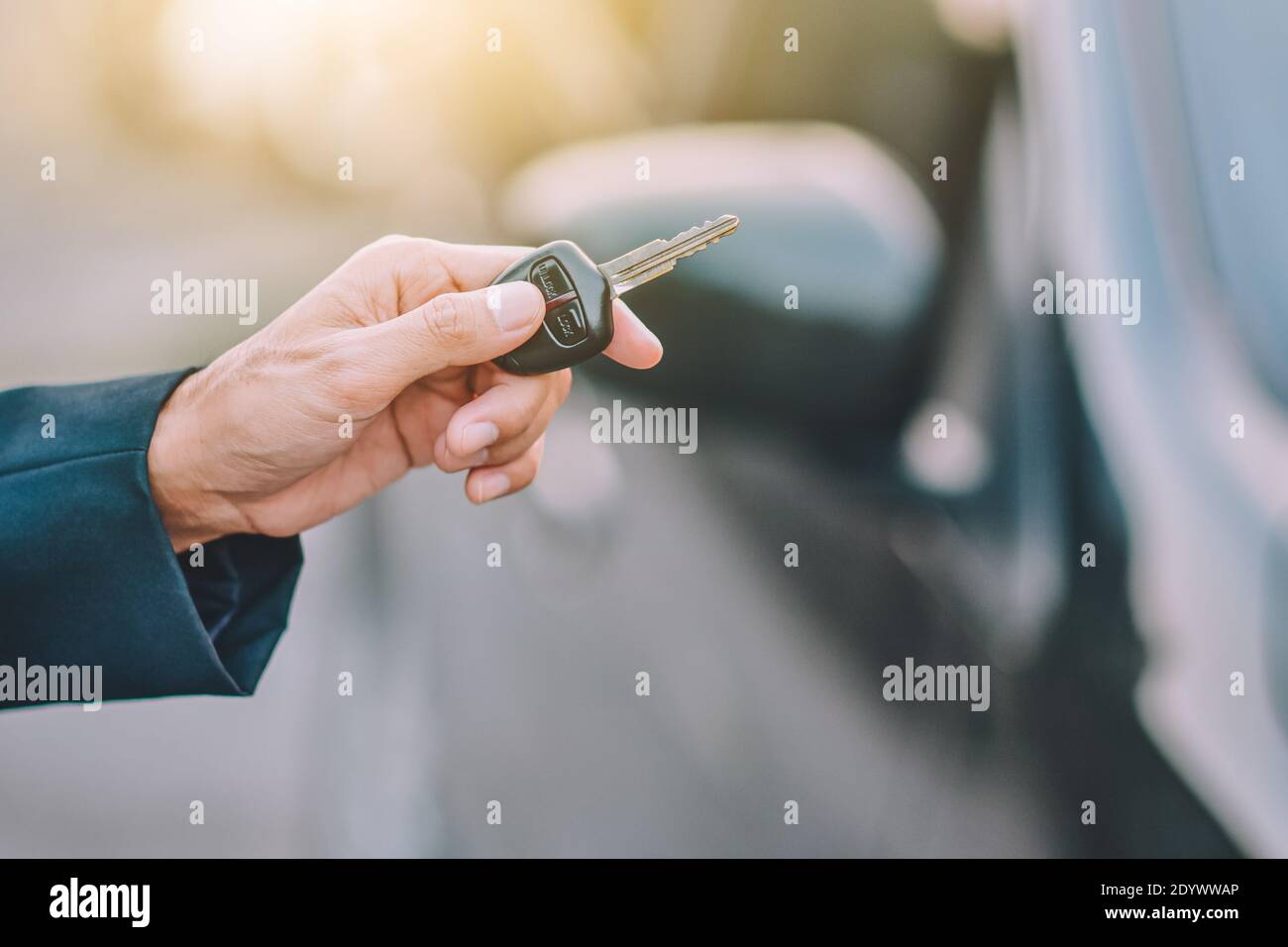 Business people holding key at car Stock Photo - Alamy