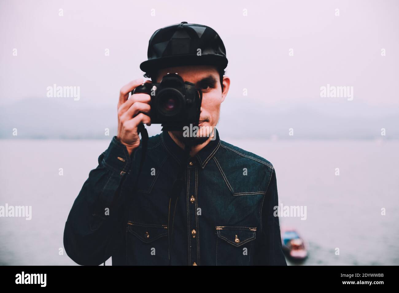 One man Travel around the world with one camera,Man holding camera on ...