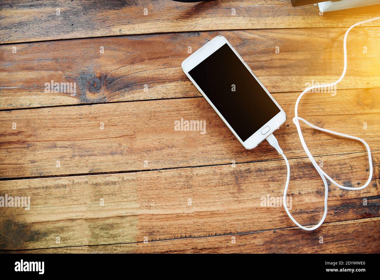 Smart phone on wooden table copy spec for texture concept or design ...