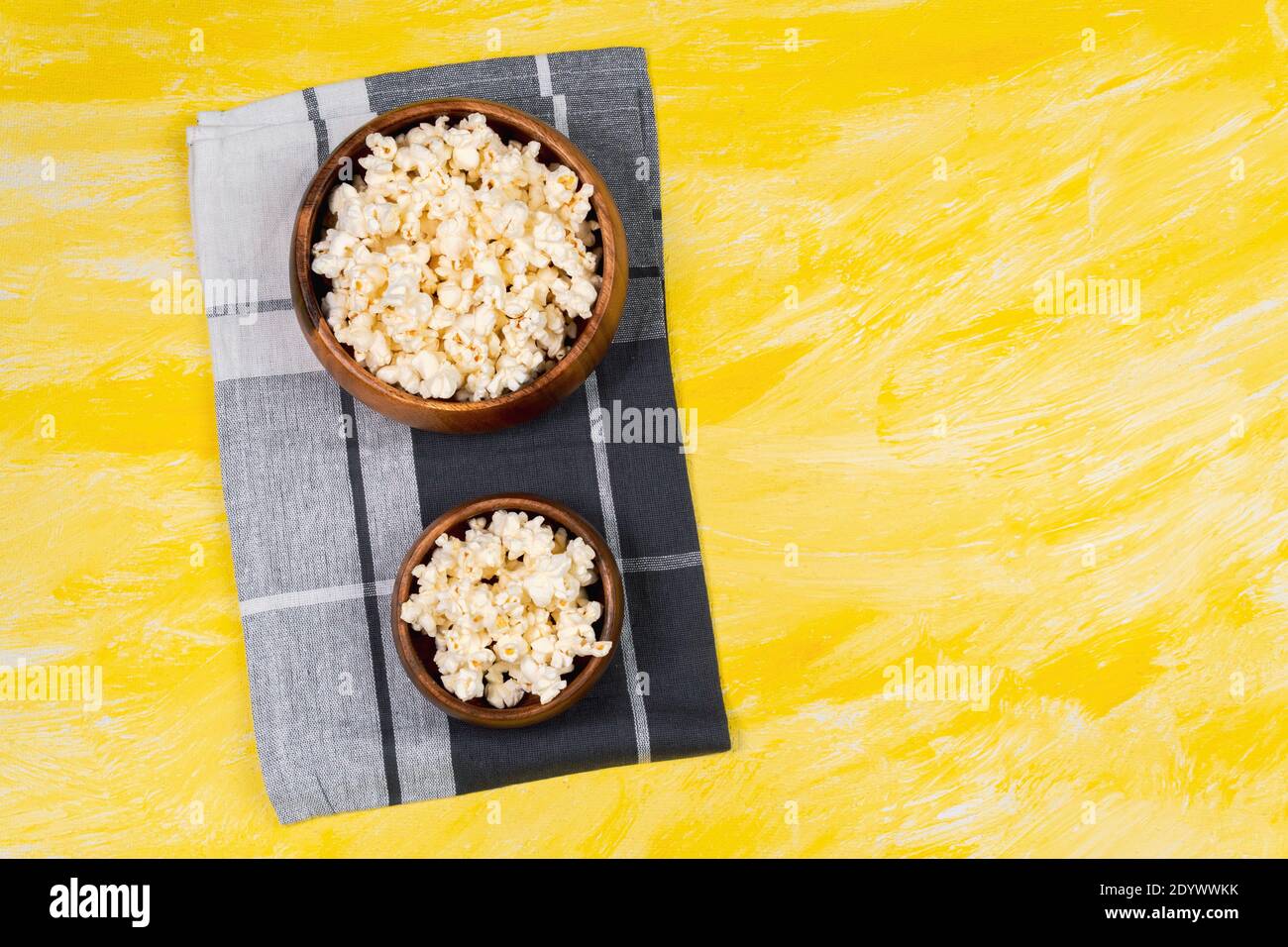Popcorn on a yellow background. Film. Fast food. Corn. top view with ...