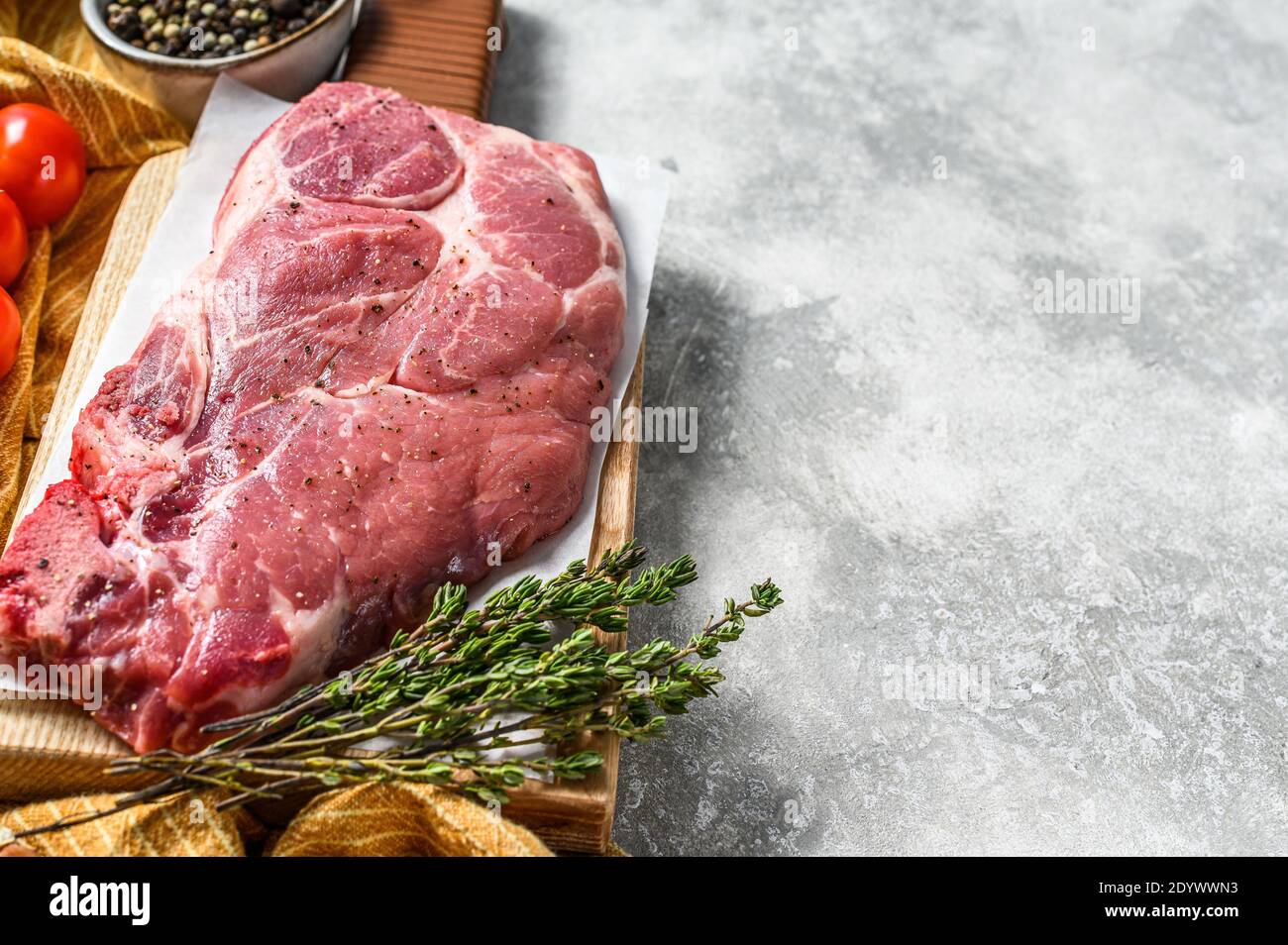Raw pork marbled steak on a chopping Board. Gray background. Top view ...