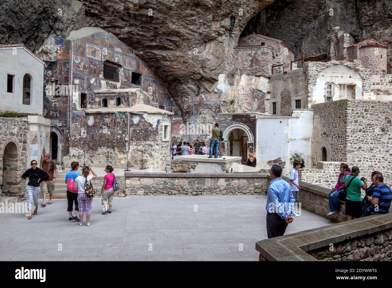 Tourists gather around the Rock Church of Sumela Monastery which is a ...