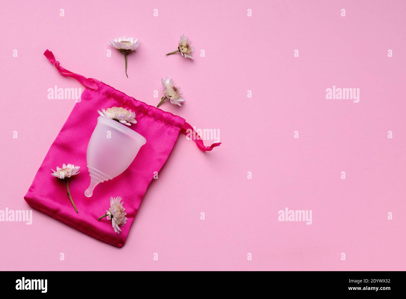 Menstrual cup with flowers on pink background Stock Photo - Alamy