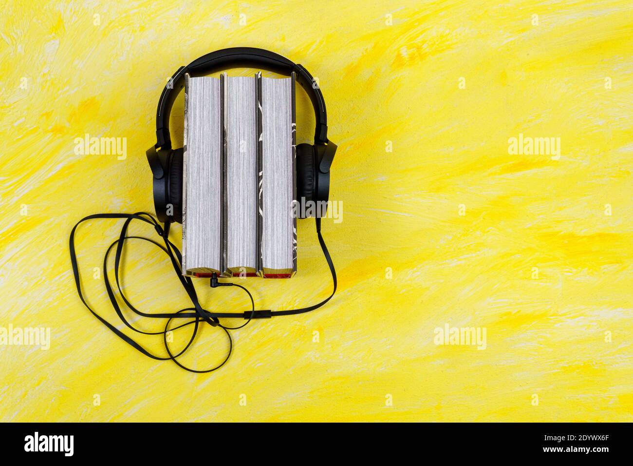 Audio book concept. Headphones, book stone table. Top view with space ...