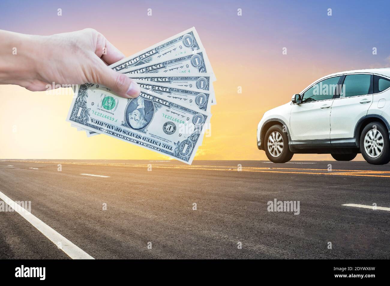 Hand holding money dollar and car driving on road background Stock ...