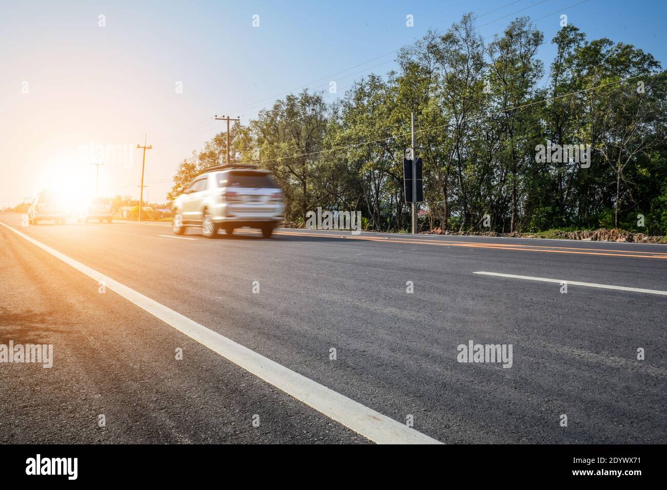 Car driving speed fast on road Stock Photo - Alamy