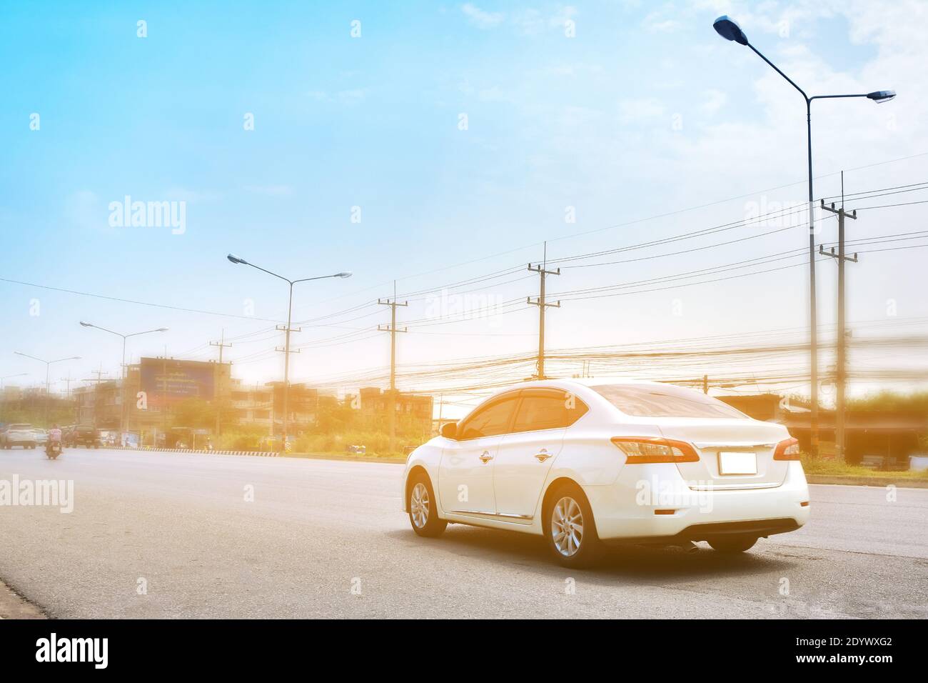 White car driving on road Stock Photo - Alamy