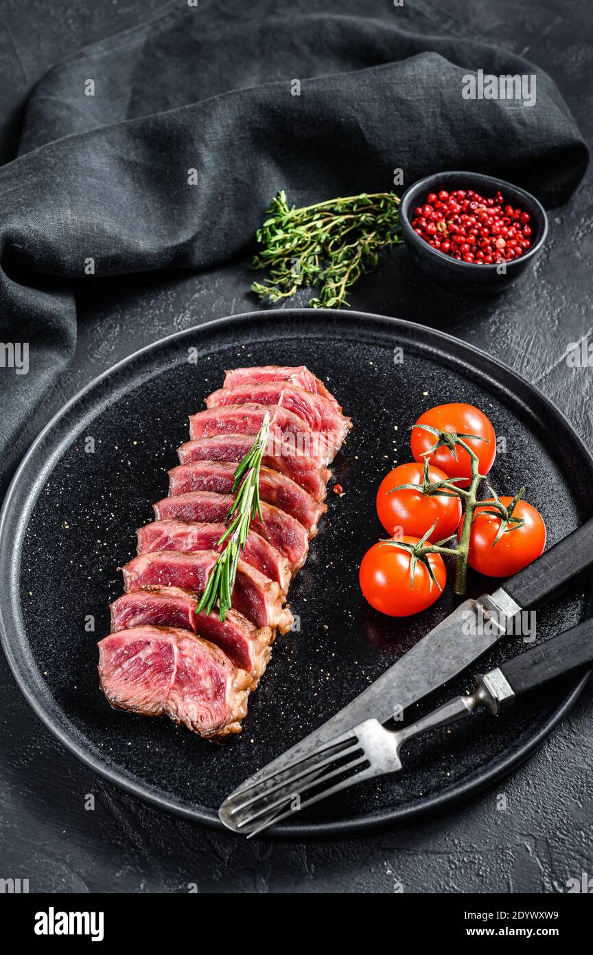 Sliced beef steak Top Blade, black Angus. Black background. Top view ...